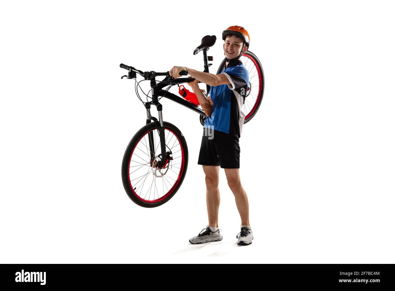 Young Caucasian boy bike rider with road bike isolated over white ...