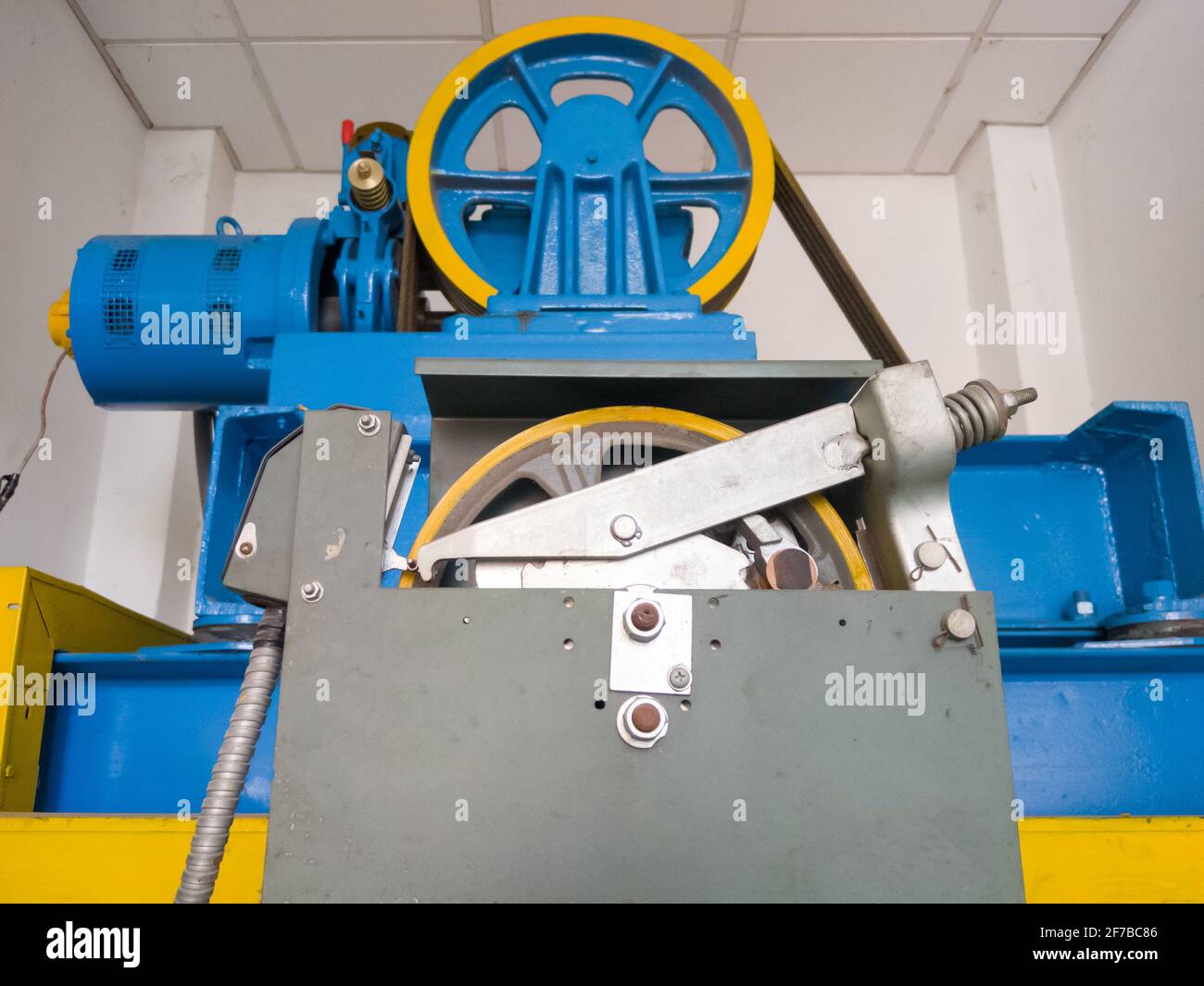 The large circle wheel of the passenger elevator motor in the control ...