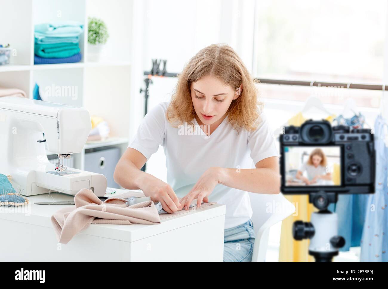 Seamstress measuring cloth for new design Stock Photo - Alamy