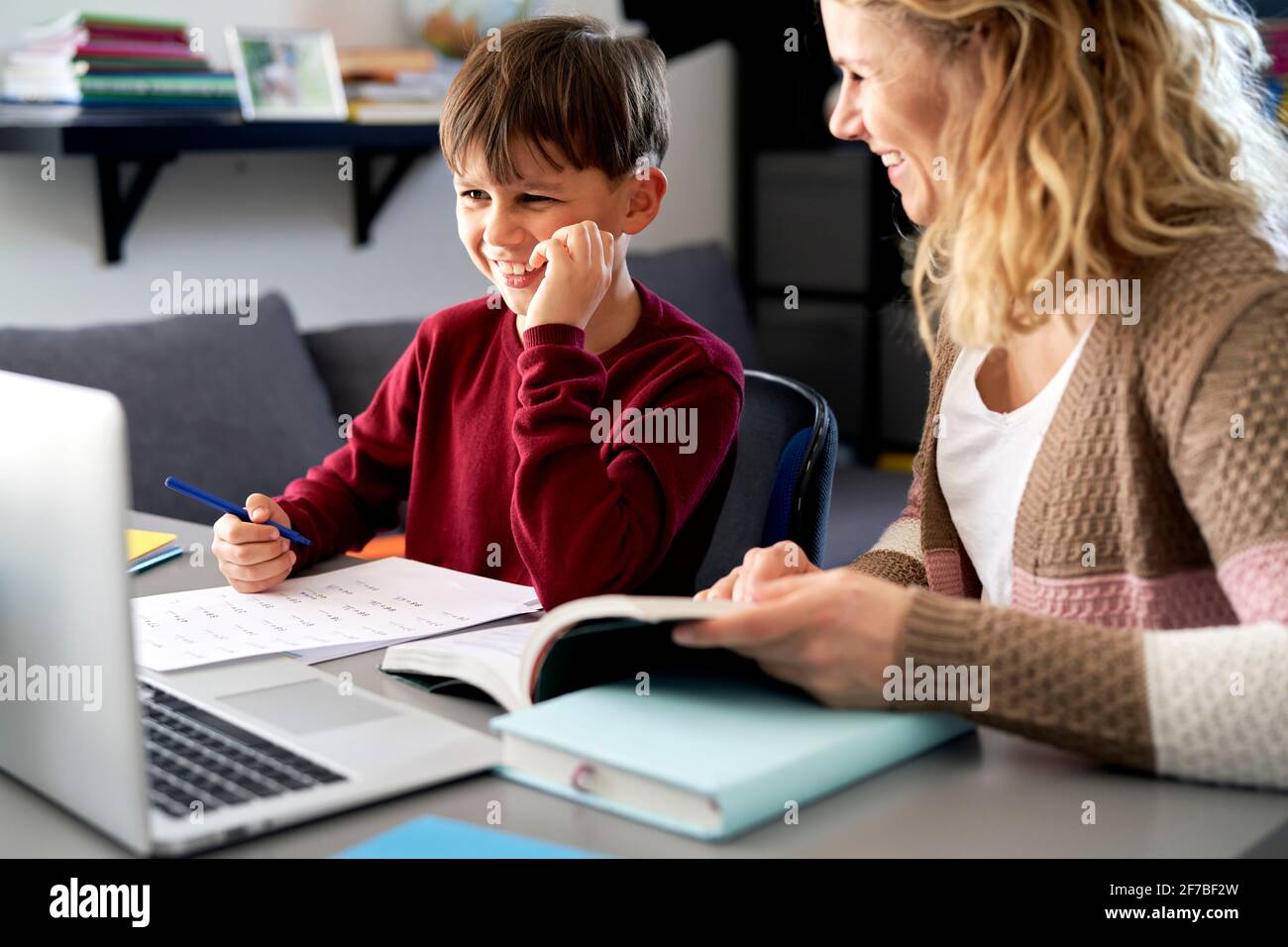 Happy mother and son doing homework together Stock Photo - Alamy