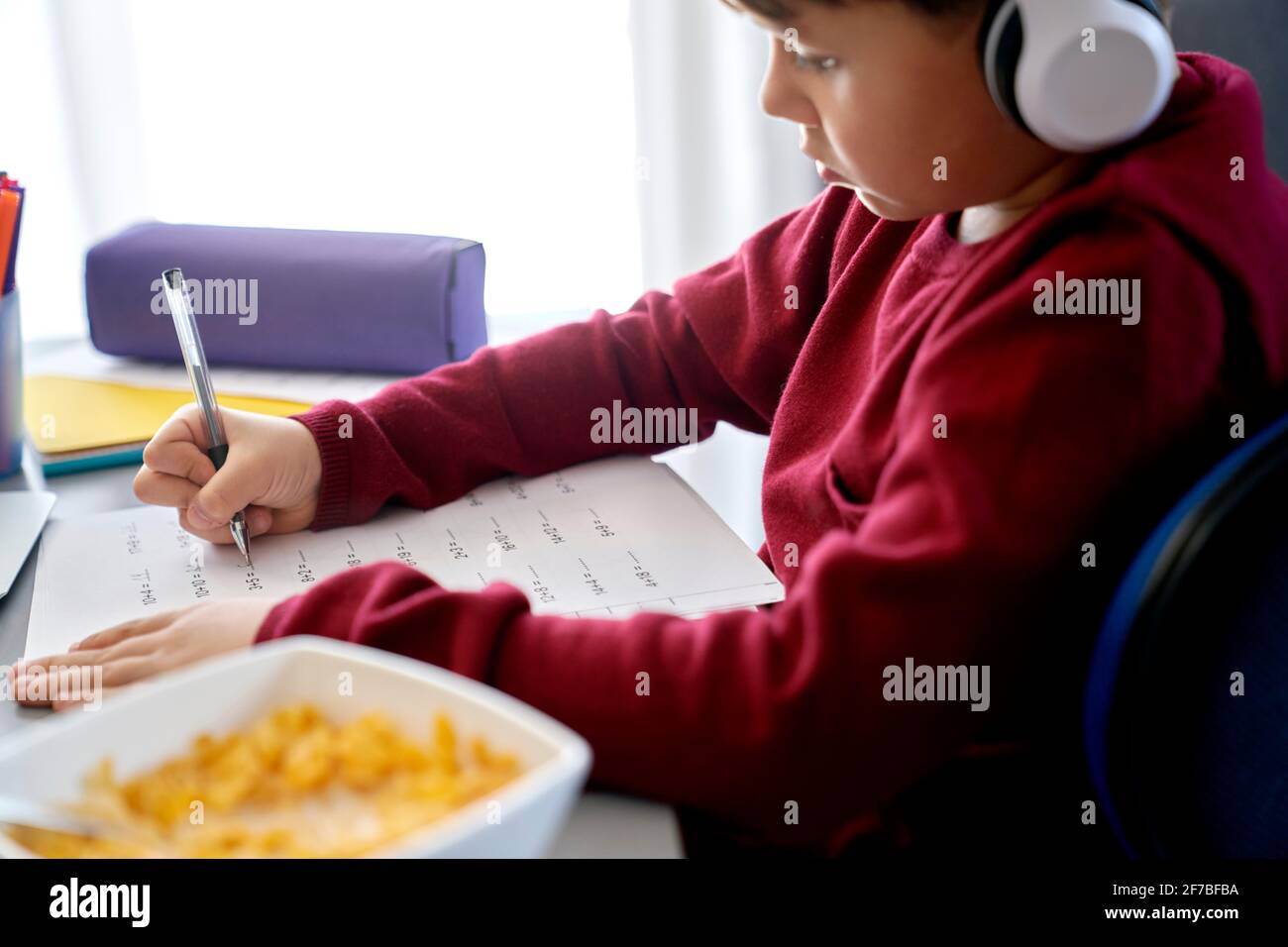 Close up side view of boy doing math homework Stock Photo - Alamy