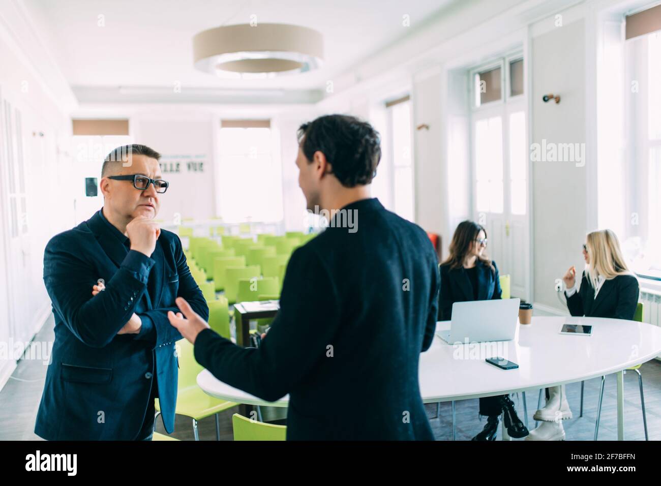 Two business men working together in the office Stock Photo - Alamy