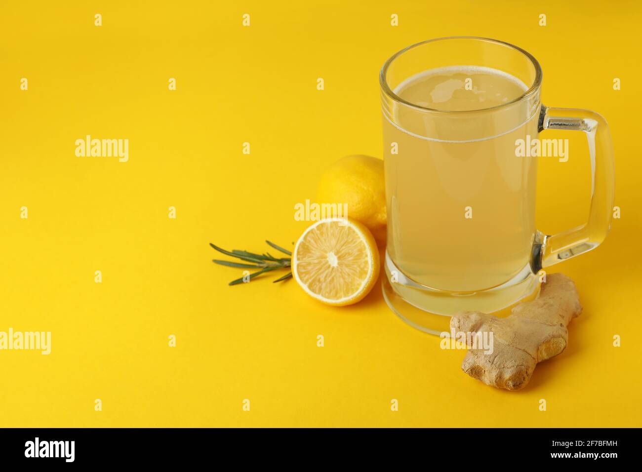 Glass of ginger beer and ingredients on yellow background Stock Photo ...