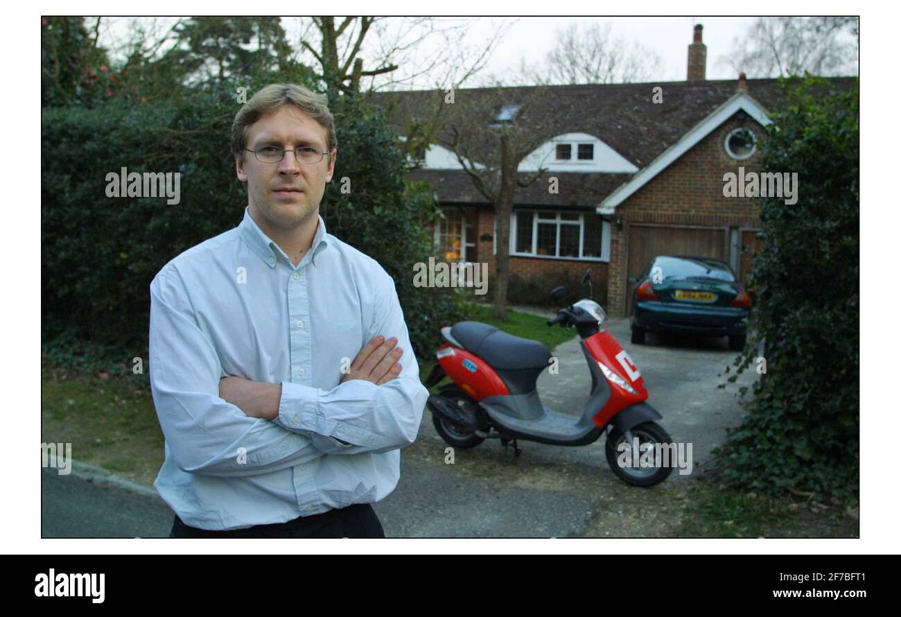 Andy Crow with his scooter at home in Woking.pic David Sandison 25/3 ...