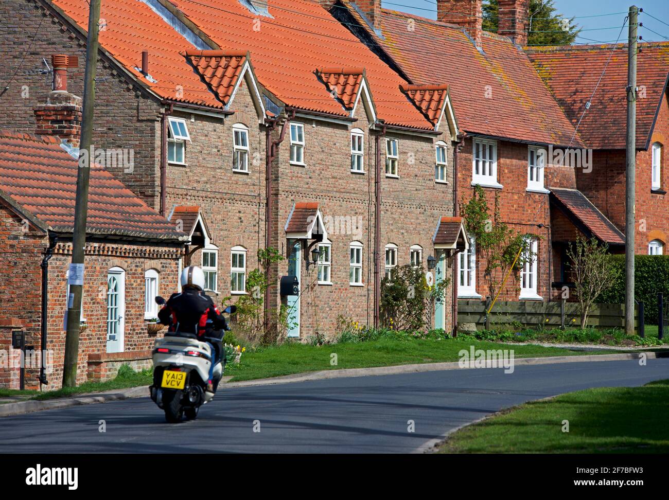 Man riding scooter in the village of Wheldrake, North Yorkshire ...