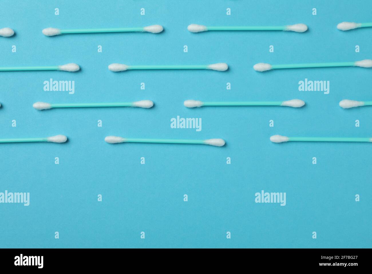 Flat lay with cotton swabs on blue background Stock Photo - Alamy