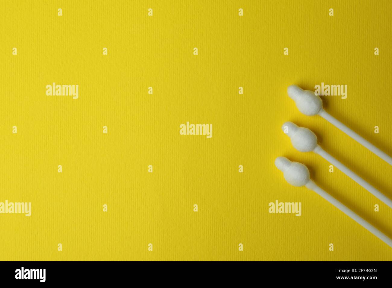 Cotton swabs on yellow background, space for text Stock Photo - Alamy