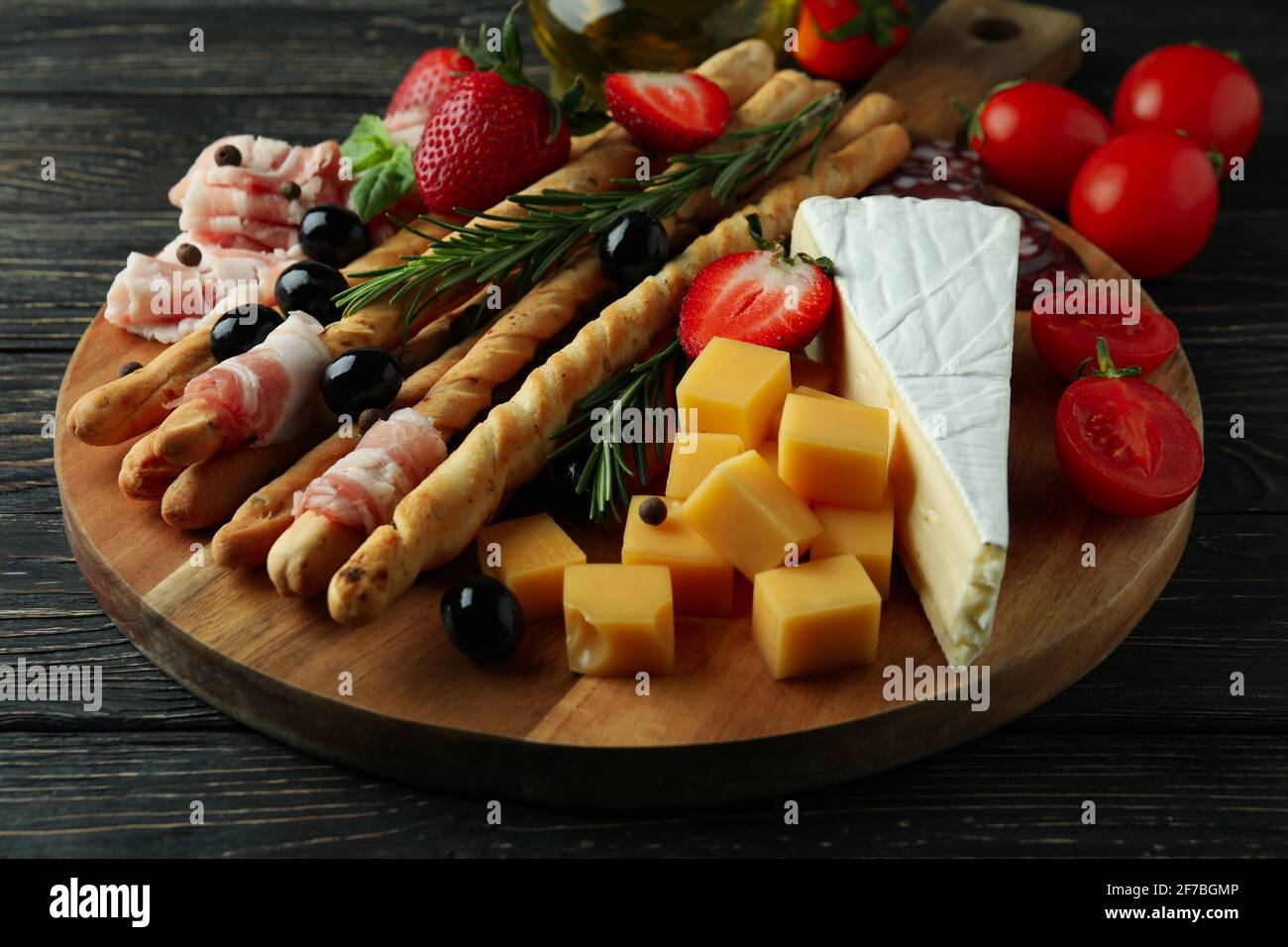 Board with grissini and snacks on wooden background Stock Photo - Alamy