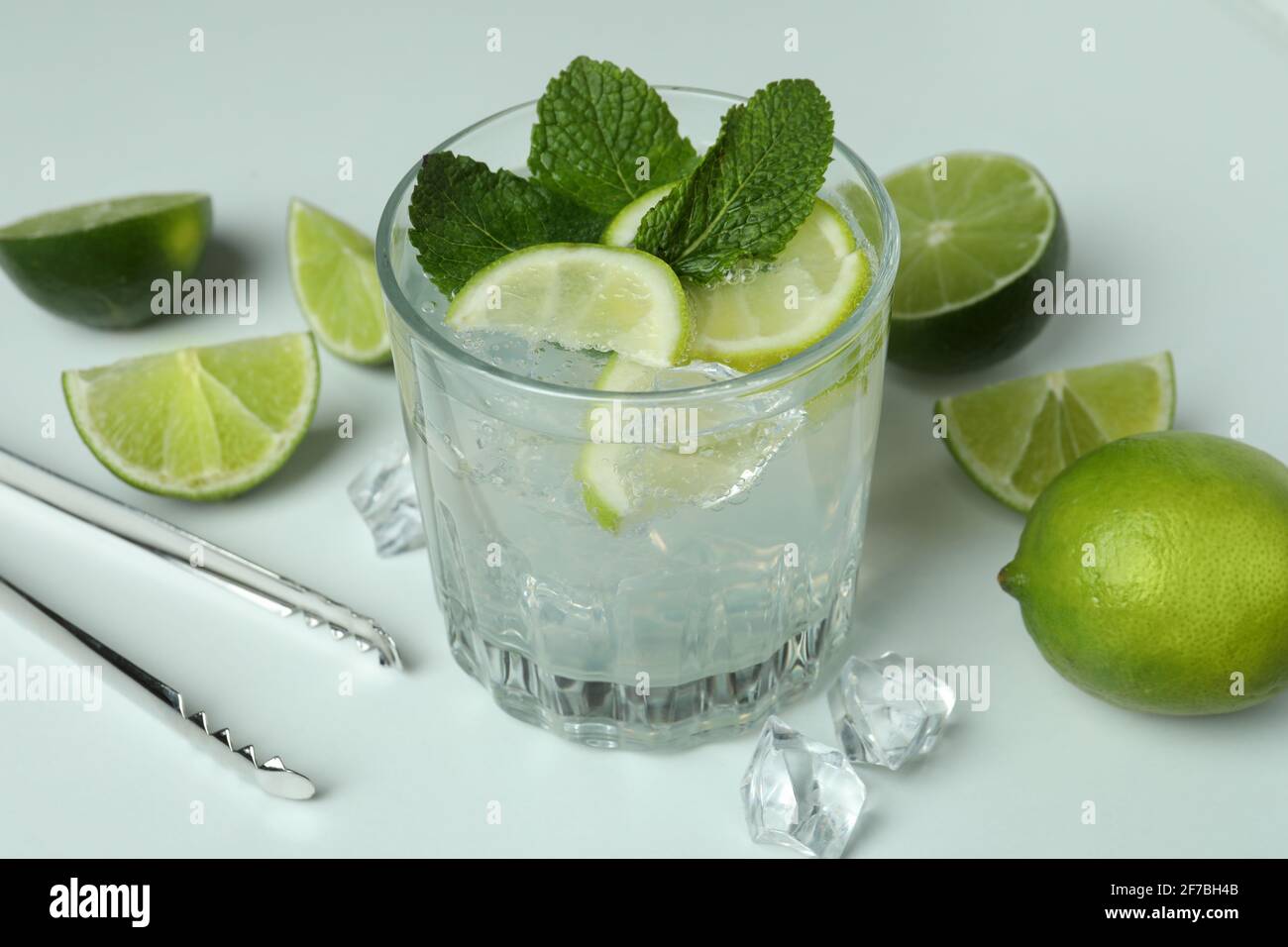 Glass of mojito cocktail and ingredients on white background Stock ...