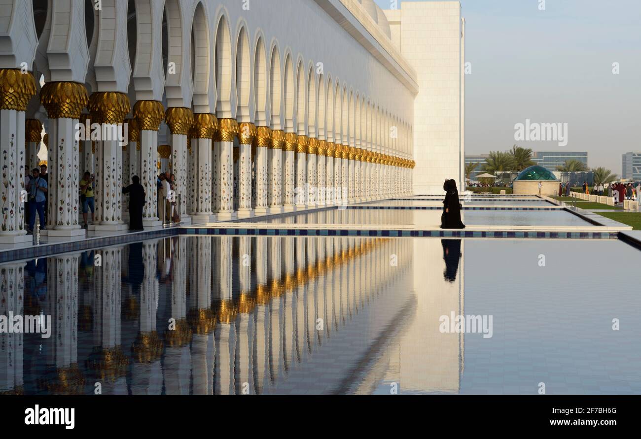 Tourists admiring the water basin and arcades of the Sheikh Zayed ...