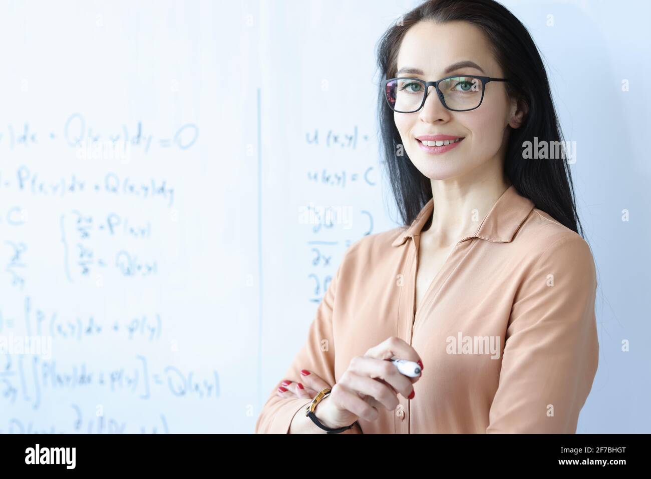 Woman teacher with glasses stands near white board Stock Photo - Alamy Woman teacher with glasses stands near white board Stock Photo - Alamy