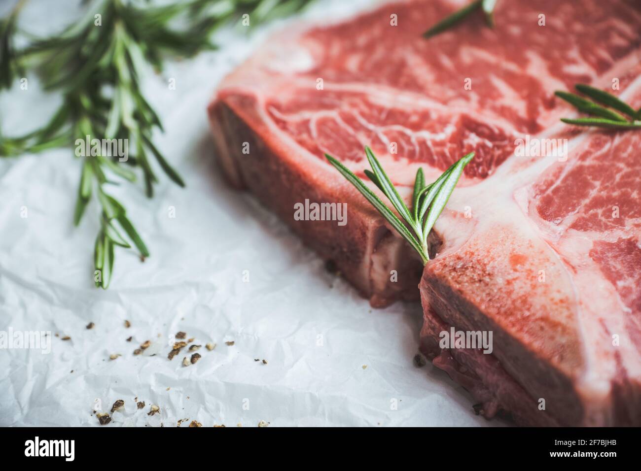 Raw fresh marble T-bone meat on the rustic background. Selective focus ...