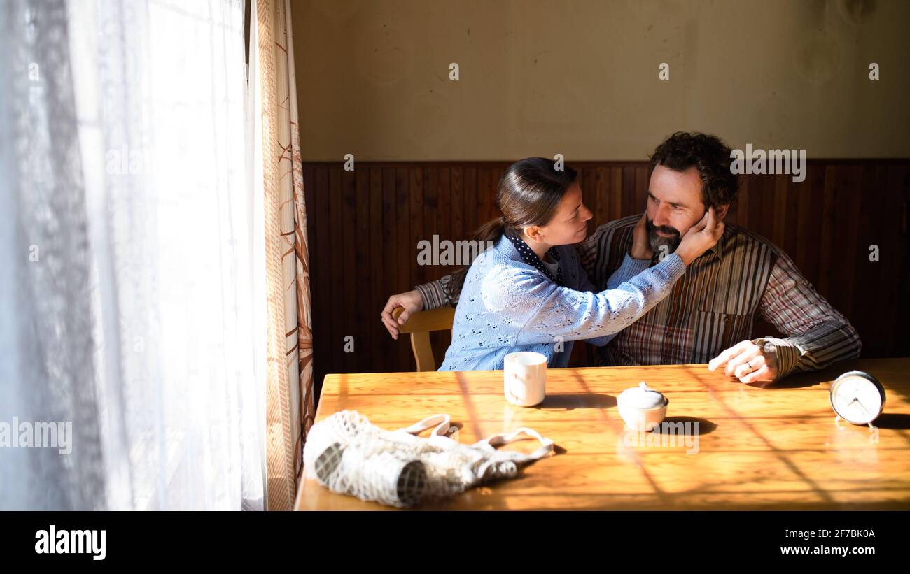 Portrait of happy poor mature couple resting indoors at home, poverty ...