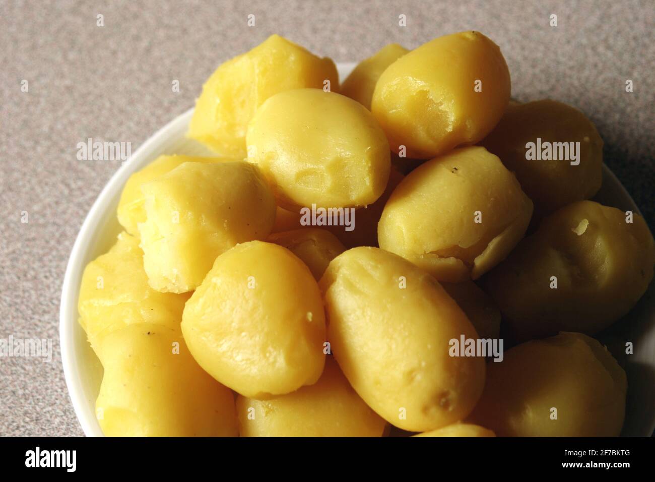 potato (Solanum tuberosum), Cooked one and peeled potatoes Stock Photo ...