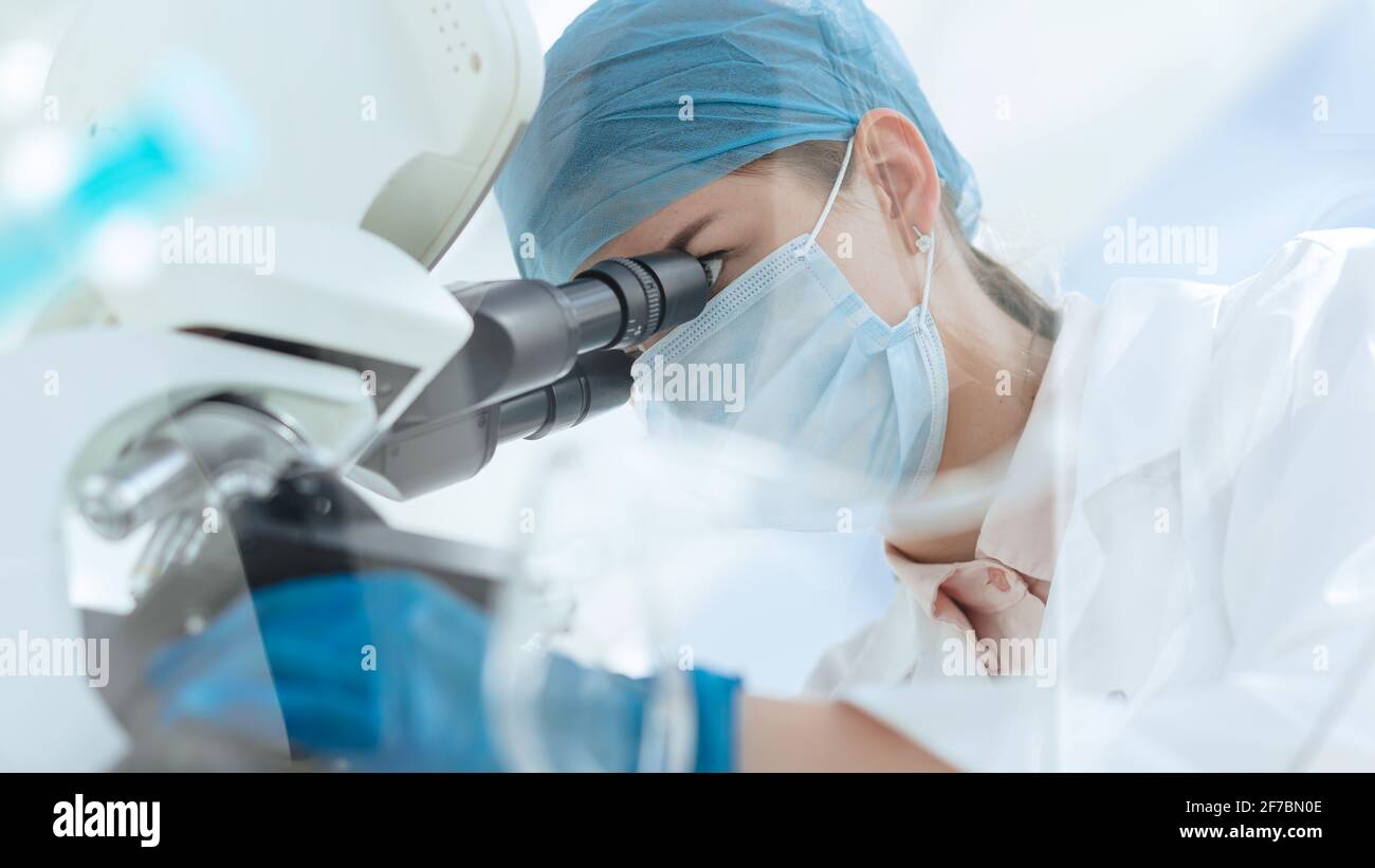 female scientist using a microscope in a medical laboratory Stock Photo ...