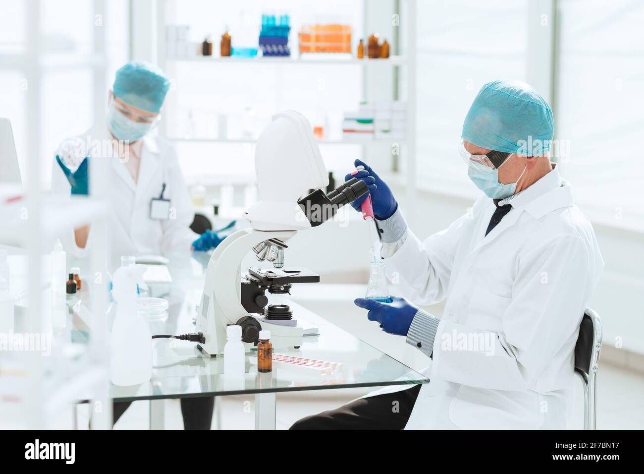 Man glasses pipette biochemistry mask hi-res stock photography and ...