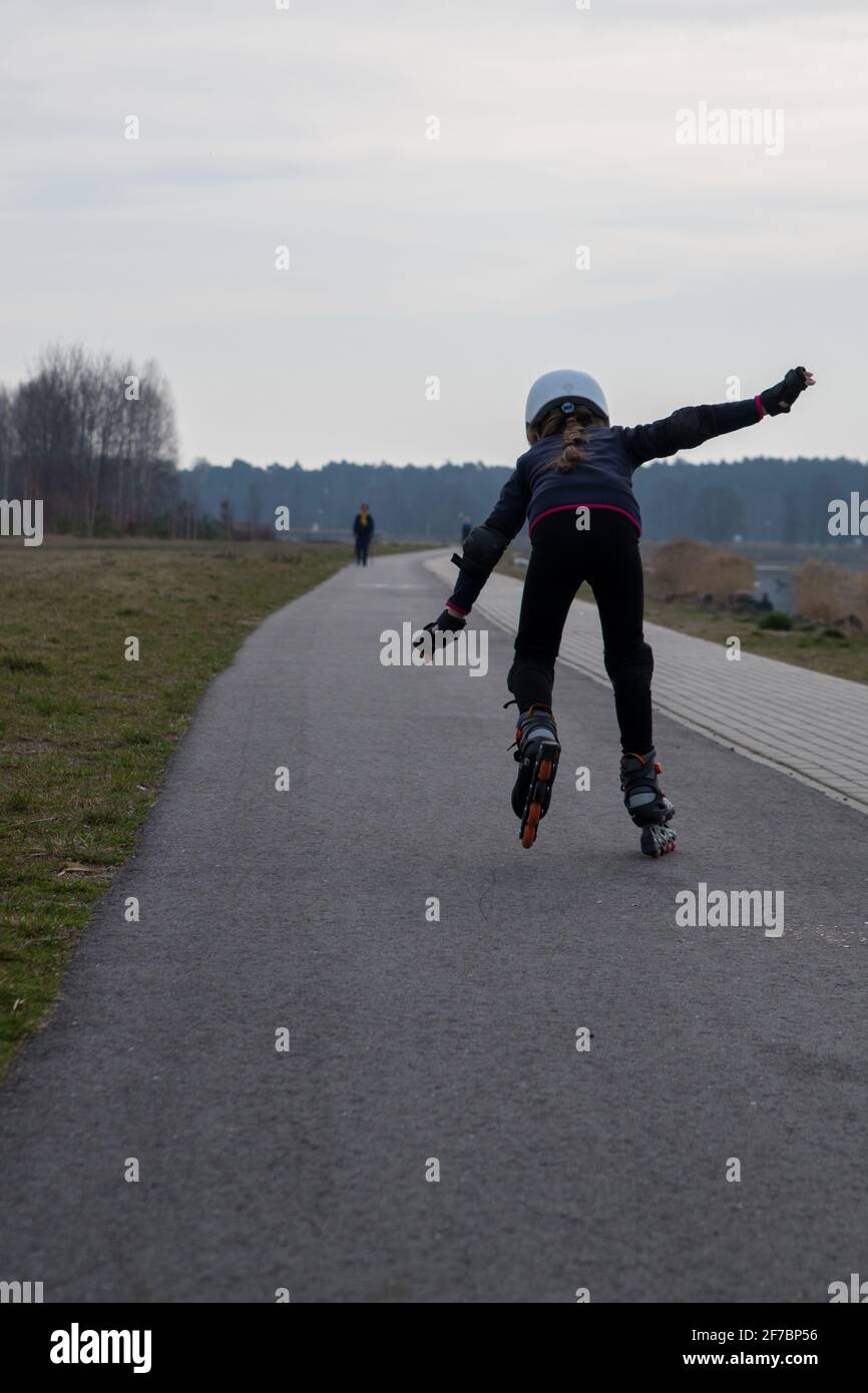 Sports accident, tripping while inline skytes, a girl is inlining. Back ...