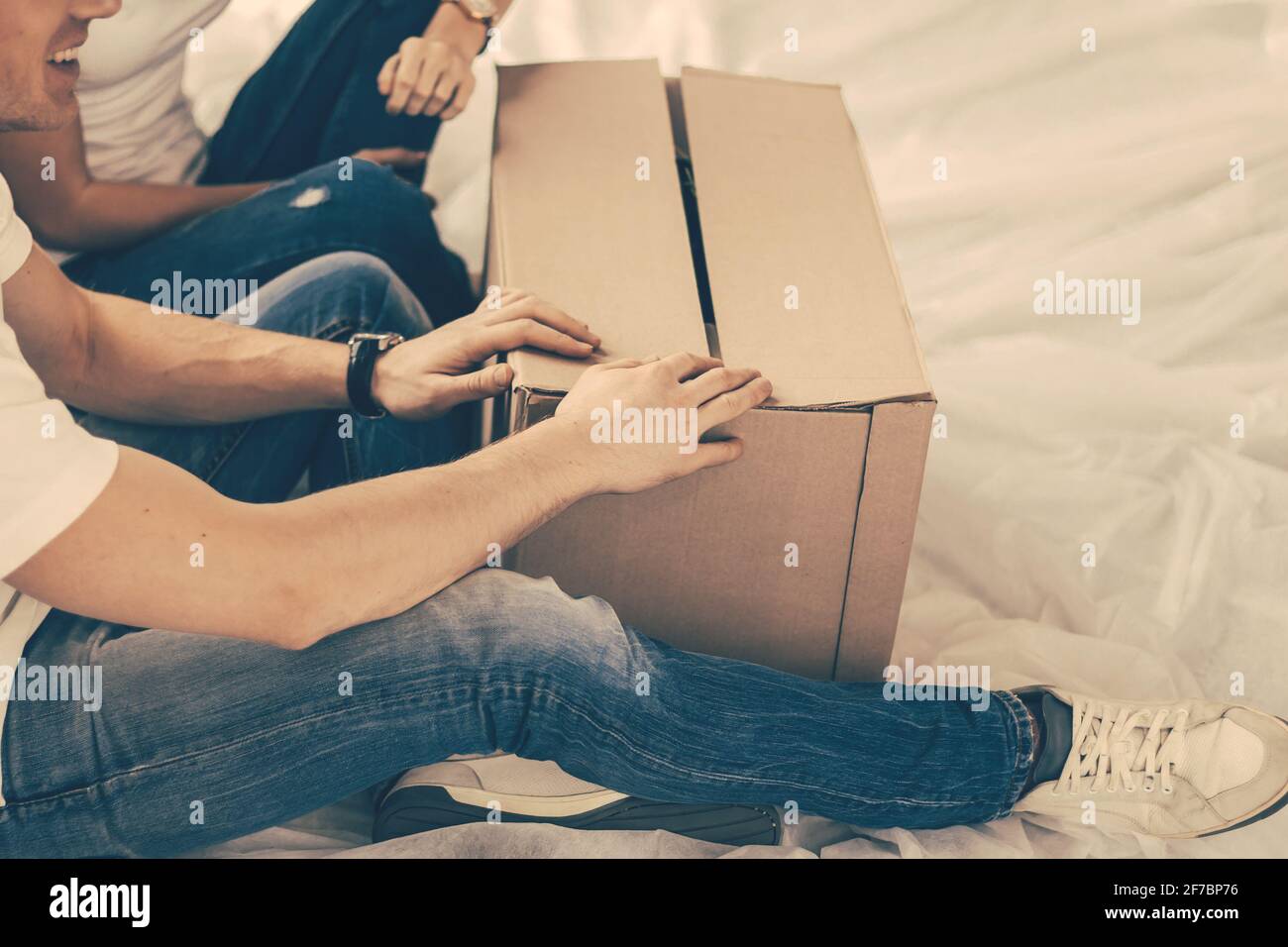 close up. couple opening a large cardboard box Stock Photo - Alamy