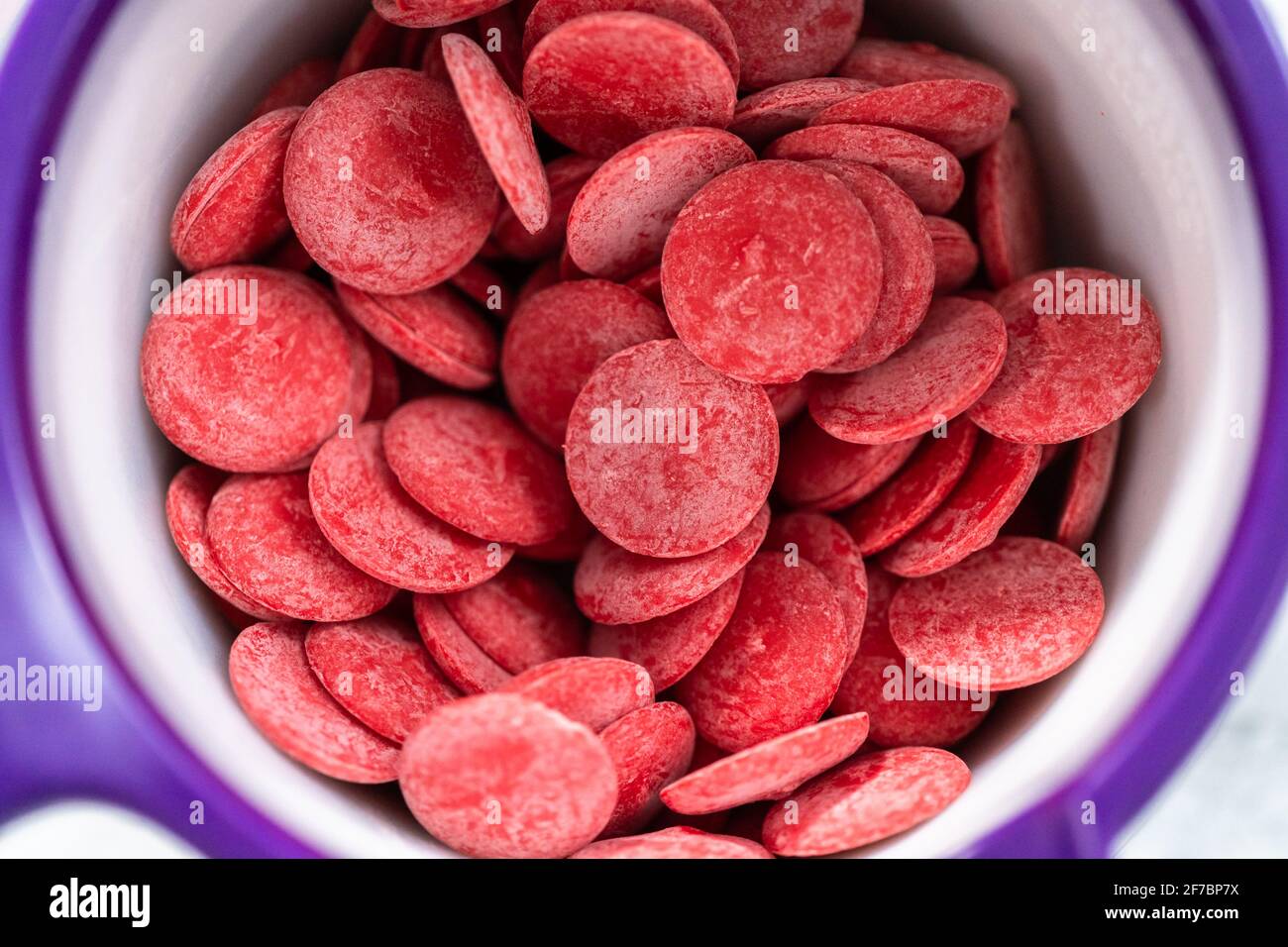 Melting red chocolate melts in the candy melting pot Stock Photo - Alamy