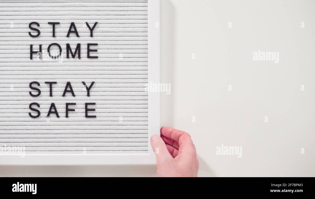 Flat lay. STAY HOME and STAY SAFE sign on message board with a homemade ...