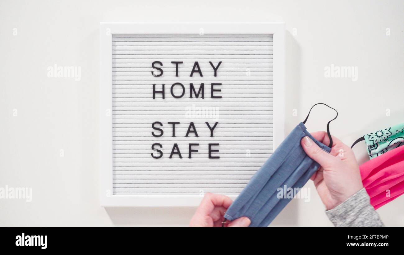 Flat lay. STAY HOME and STAY SAFE sign on message board with a homemade ...