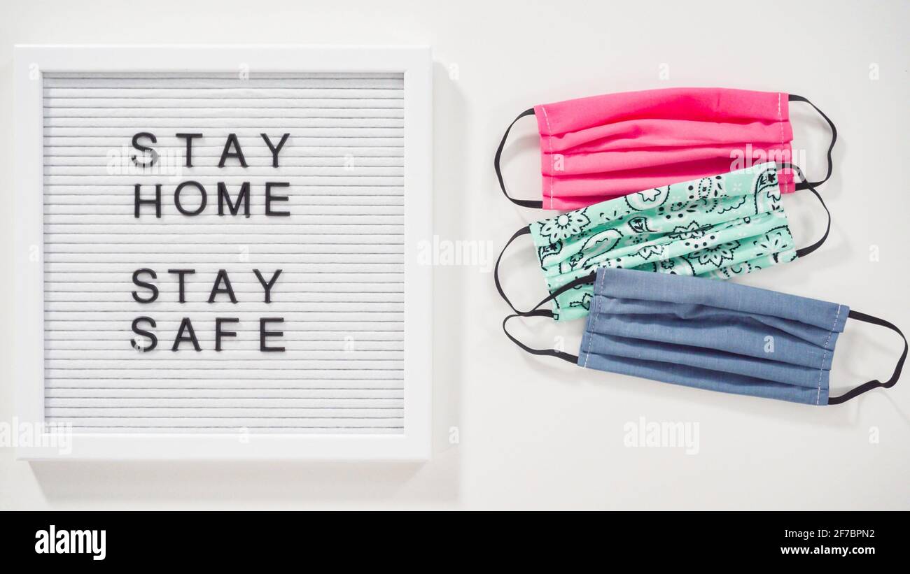 Flat lay. STAY HOME and STAY SAFE sign on message board with a homemade ...
