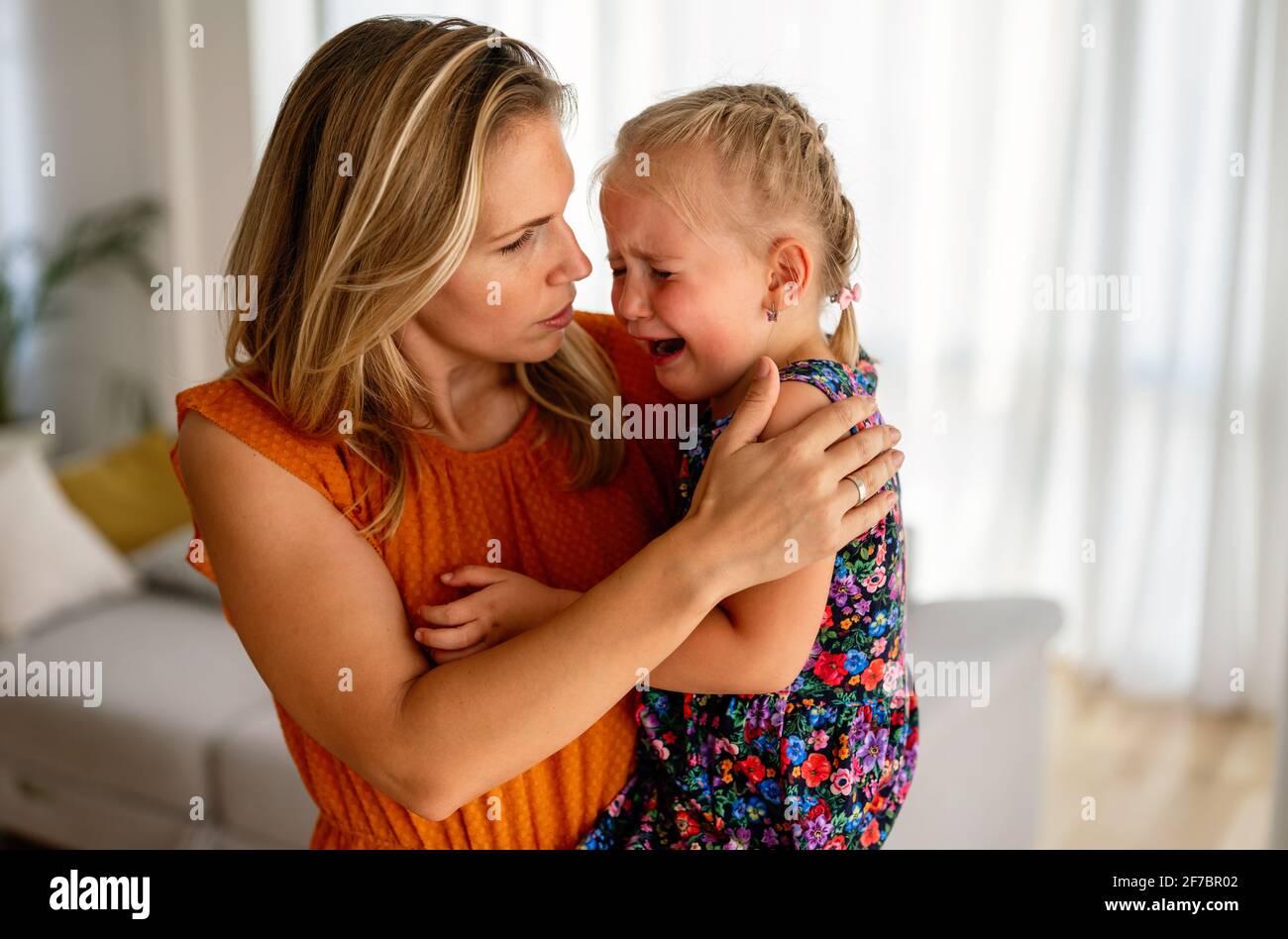 Mother comforting her crying little girl. Parenthood, family, support ...
