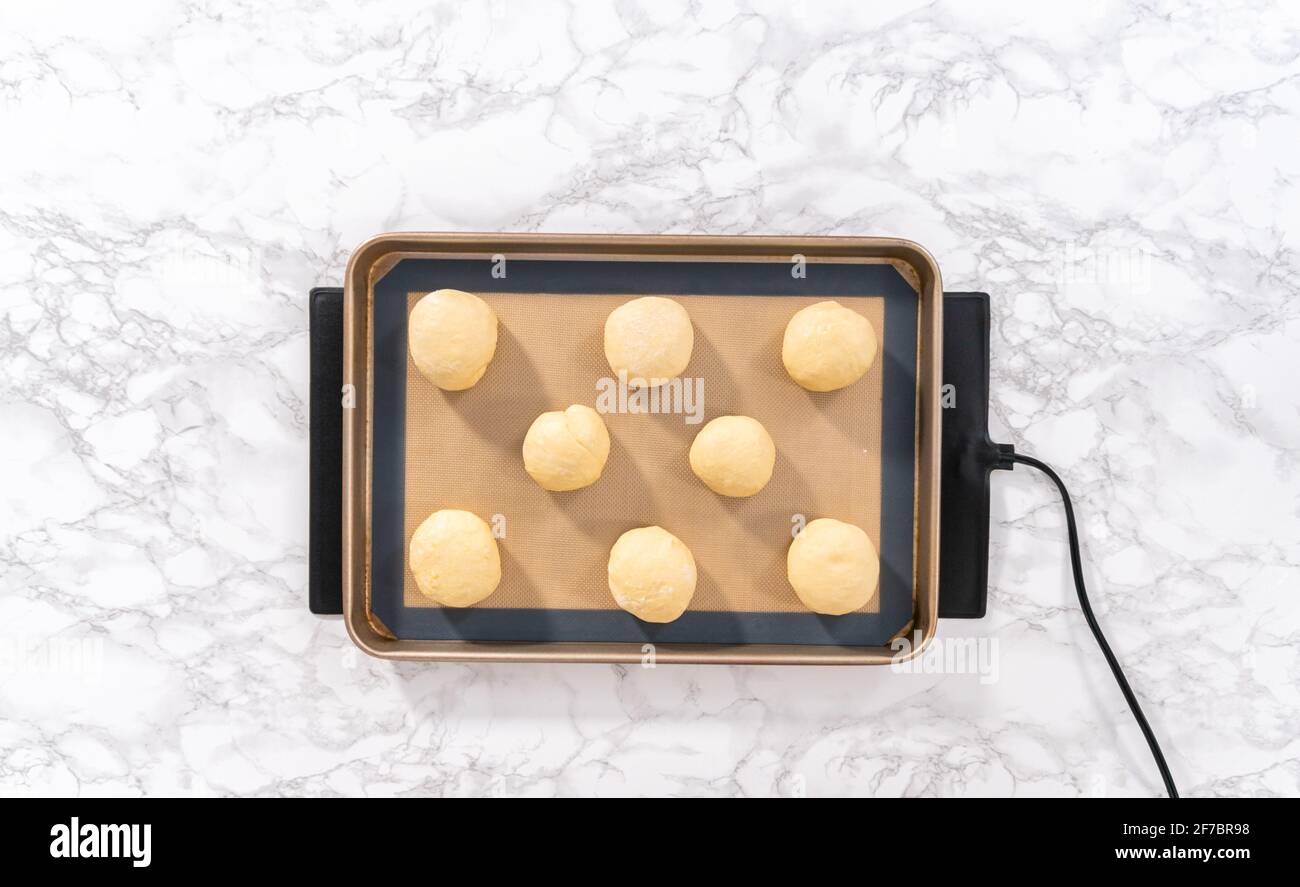 Flat lay. Rising brioche dough on a baking sheet with a silicone mat ...