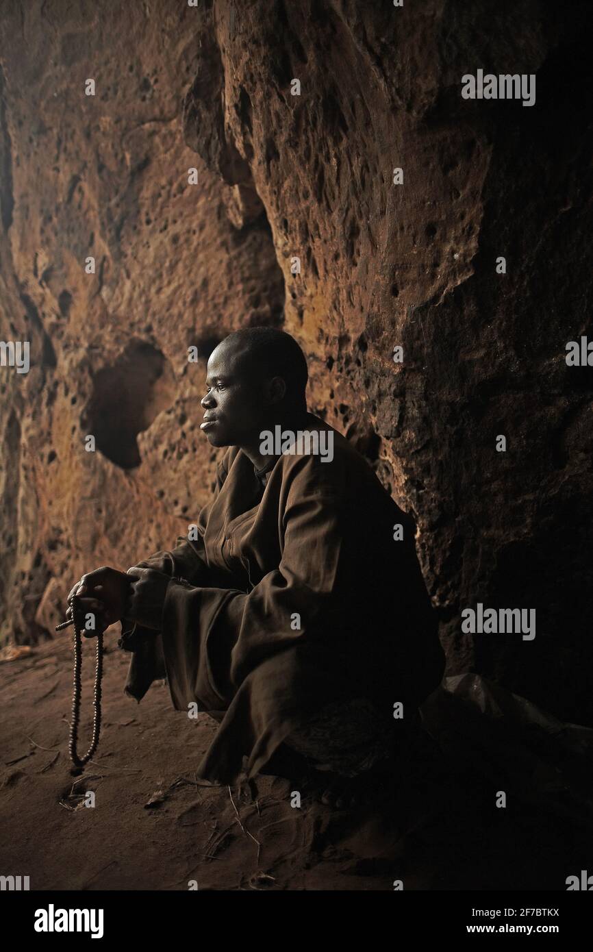 Marabout in front of the caves of Missirikoro ,Sikasso , Mali, West ...