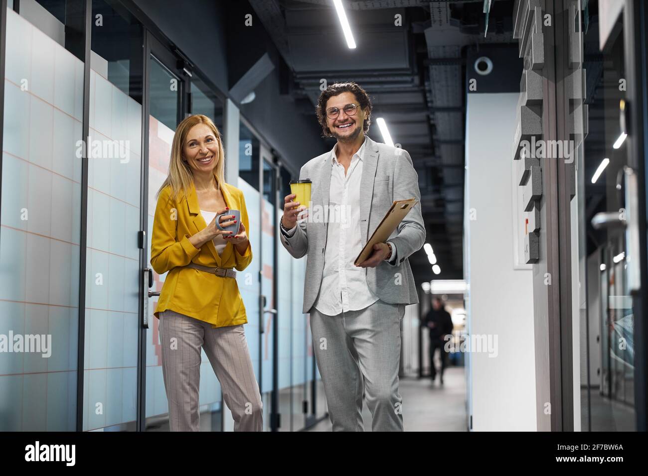 Happy young people having break after meeting Stock Photo - Alamy