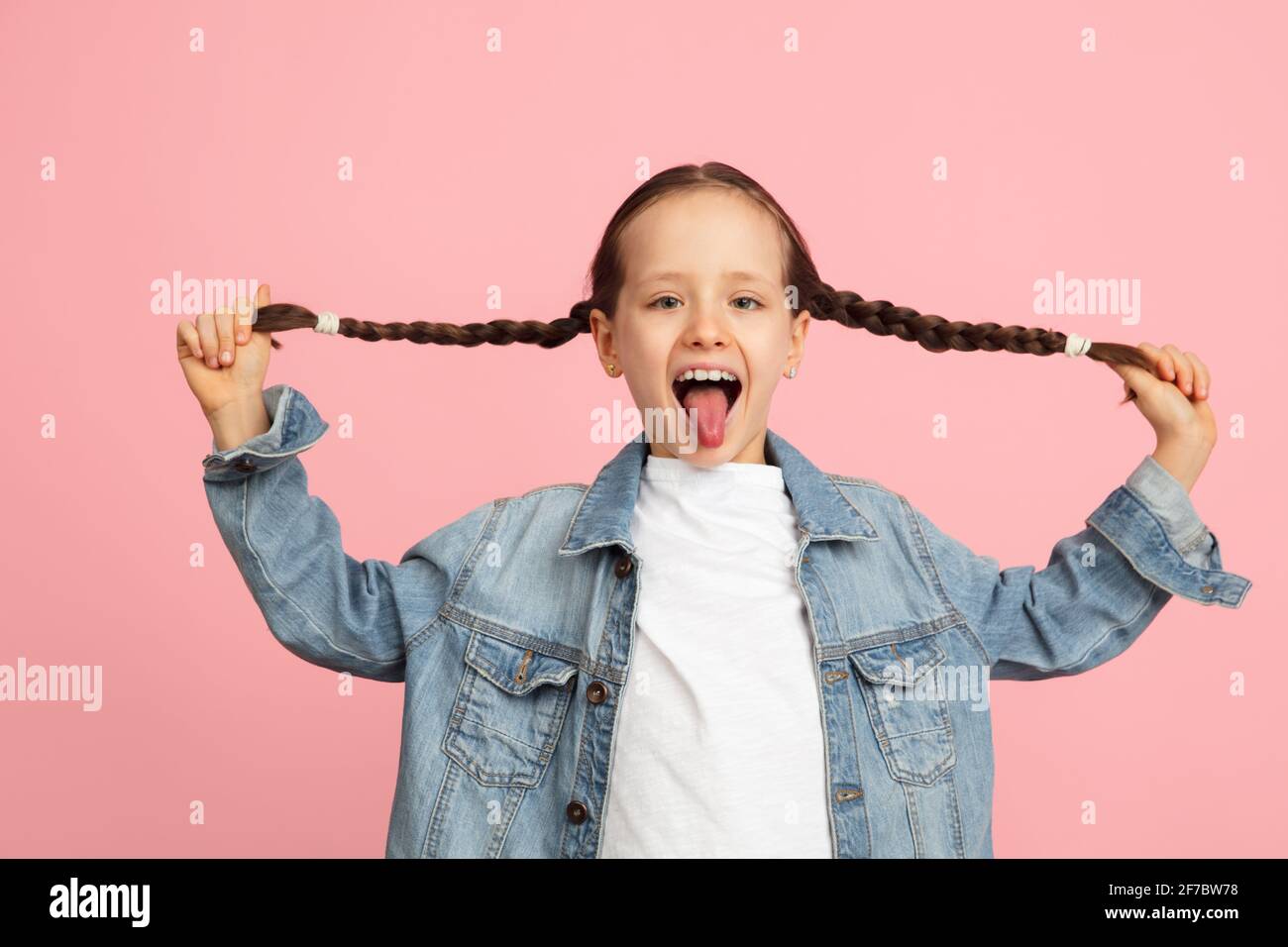 Happy kid, girl isolated on pink studio background. Looks happy ...
