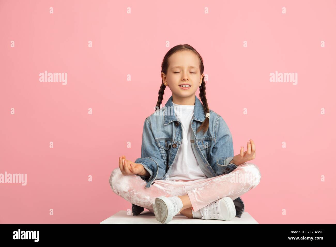 Happy kid, girl isolated on pink studio background. Looks happy ...