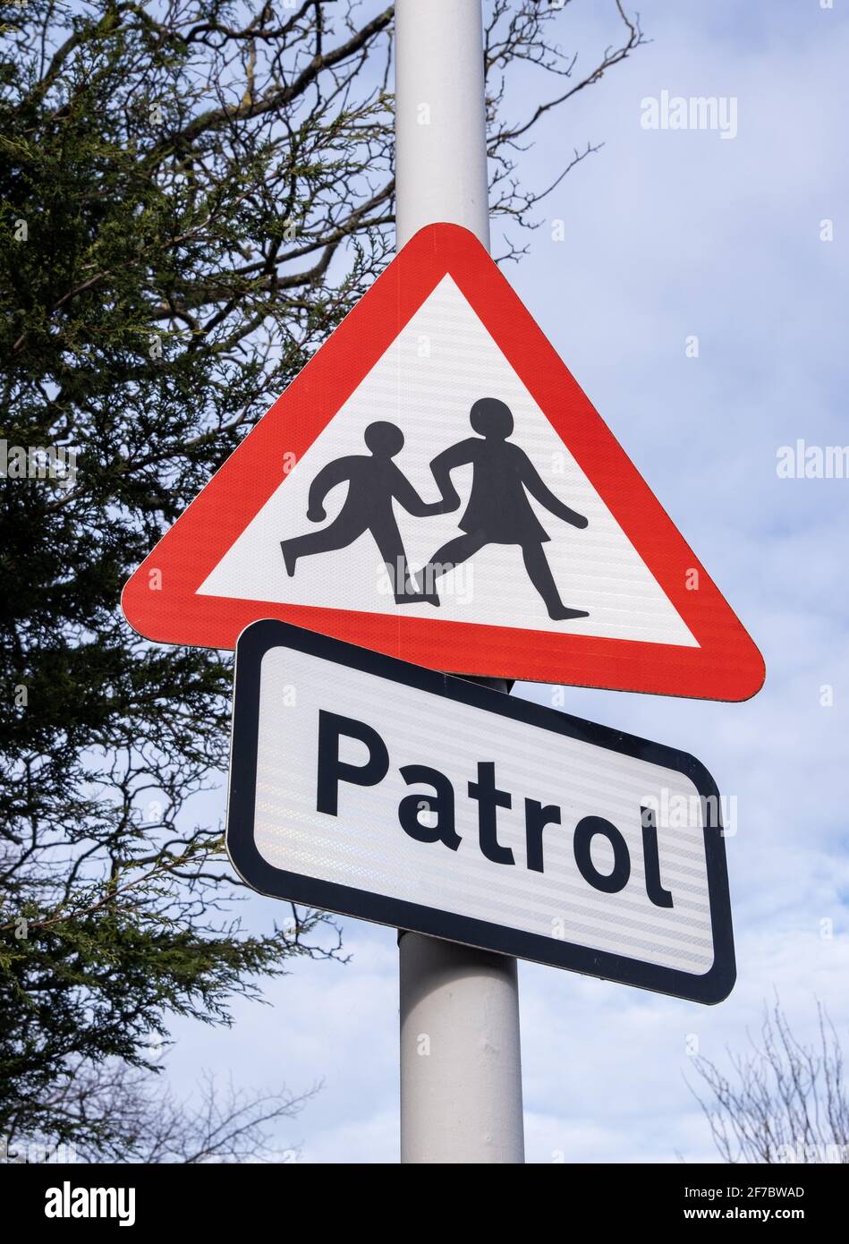 Red triangle patrol sign outside school Moreton Wirral in February 2021 ...