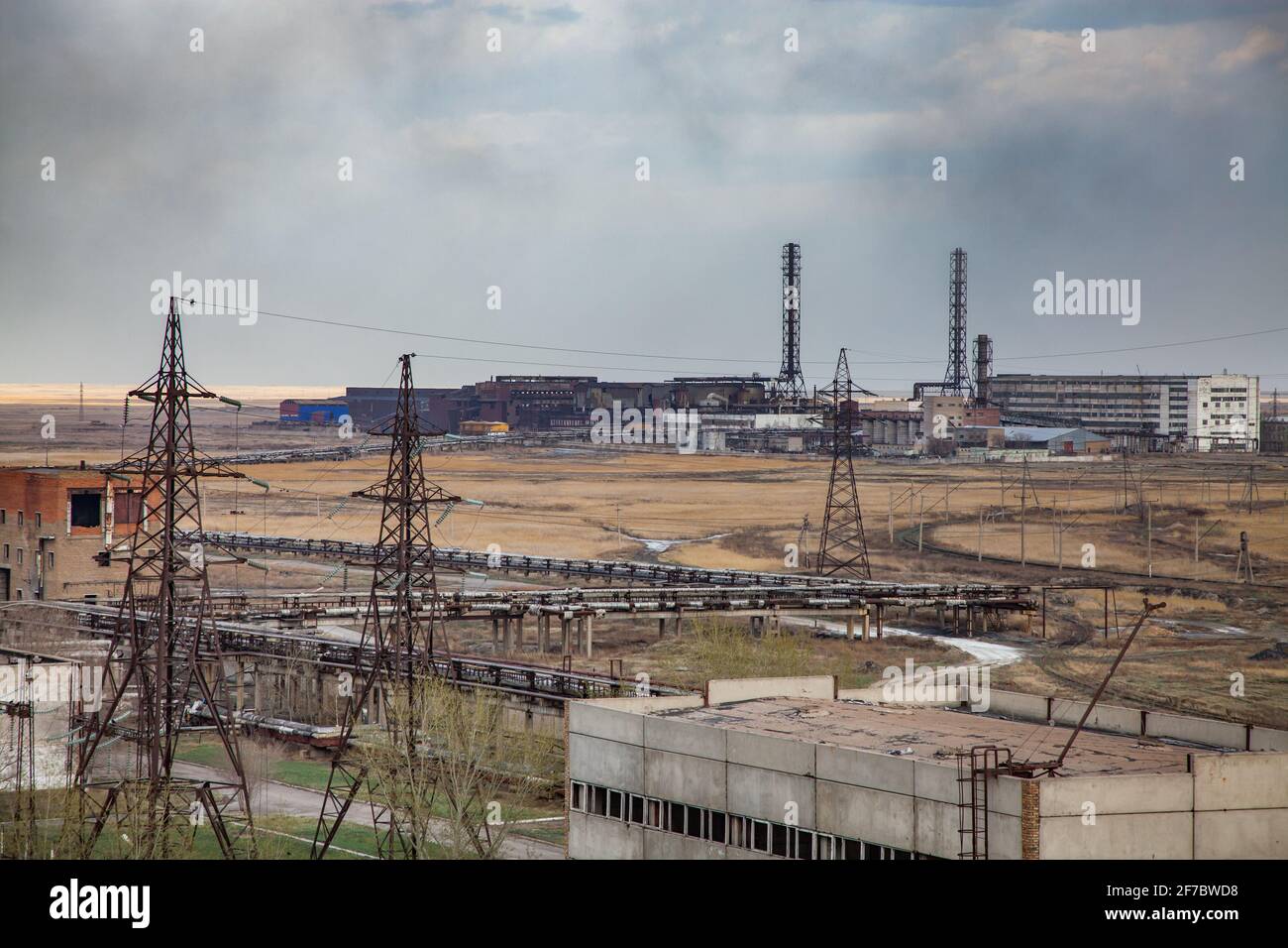 Outdated Soviet mining and processing plant. Smoke stacks and poles ...