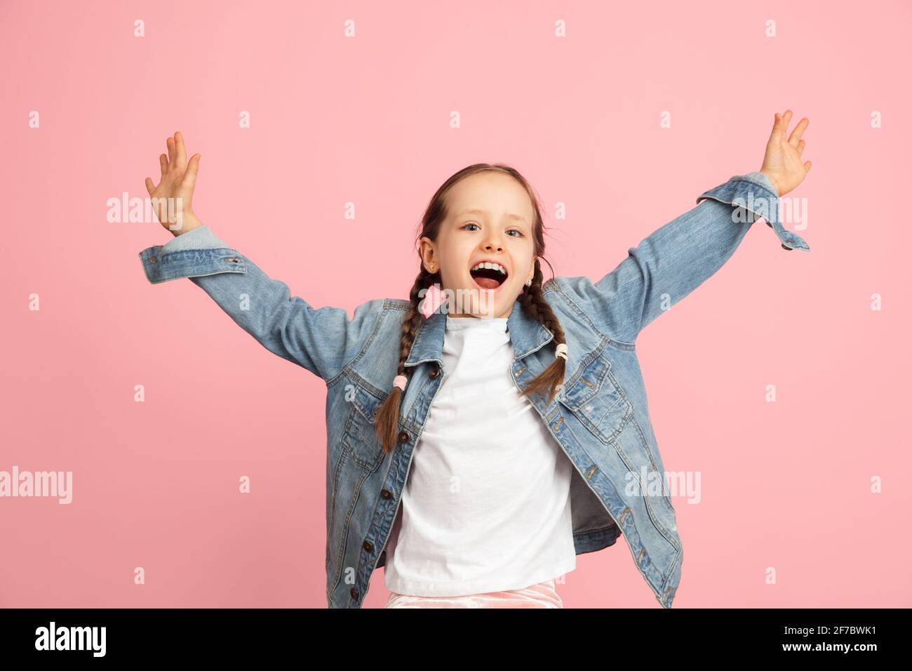 Happy kid, girl isolated on pink studio background. Looks happy ...