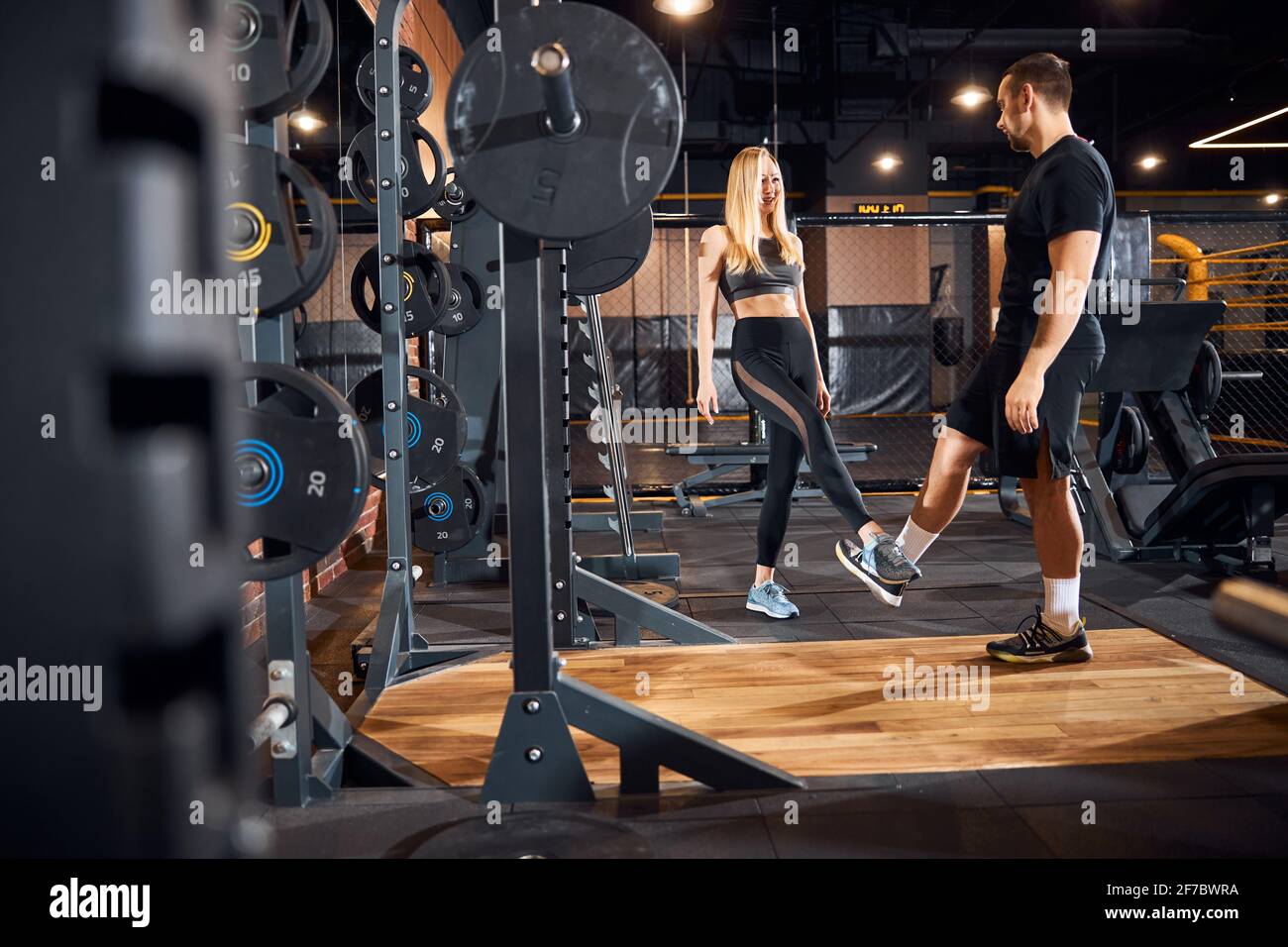 Fit young woman and her gym partner touching feet Stock Photo - Alamy
