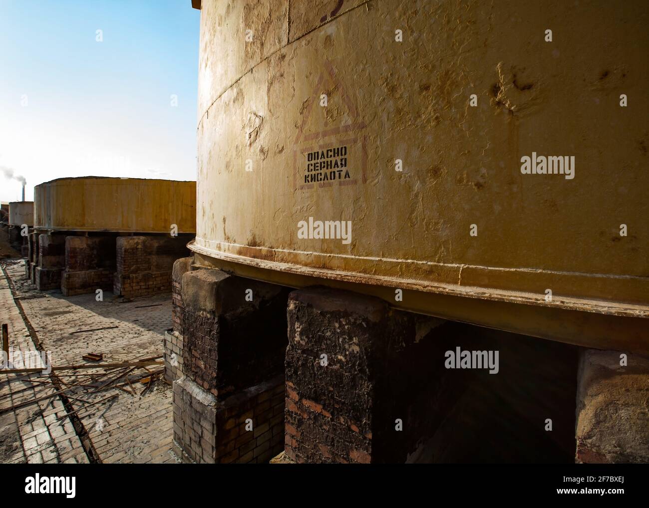 Demolition of outdated Soviet sulfuric acid plant.Old rusted yellow ...