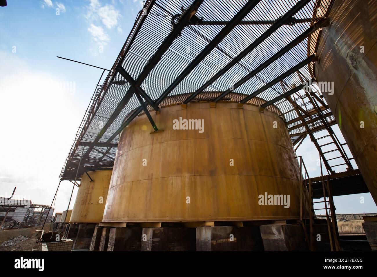 Demolition of outdated Soviet sulfuric acid plant.Old rusted yellow ...