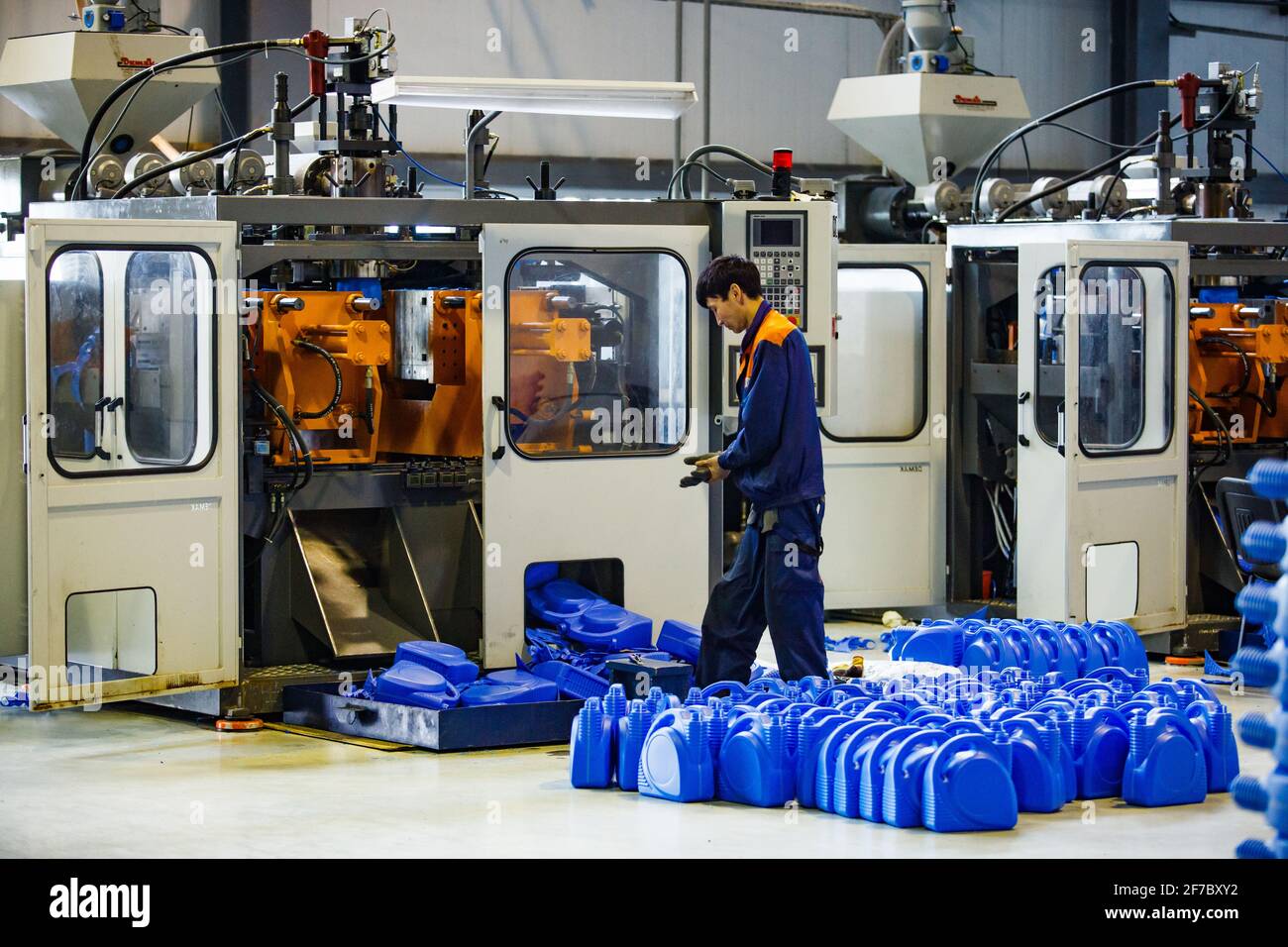 Motor oil modern production plant. Plastic punching machine for plastic ...