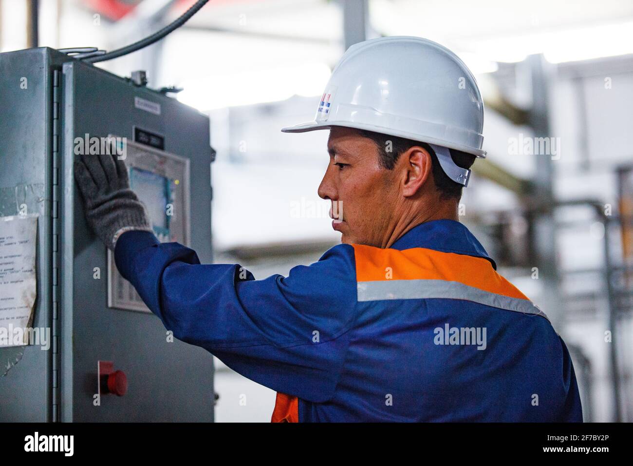 Motor oil modern production plant. Operator worker and control panel ...