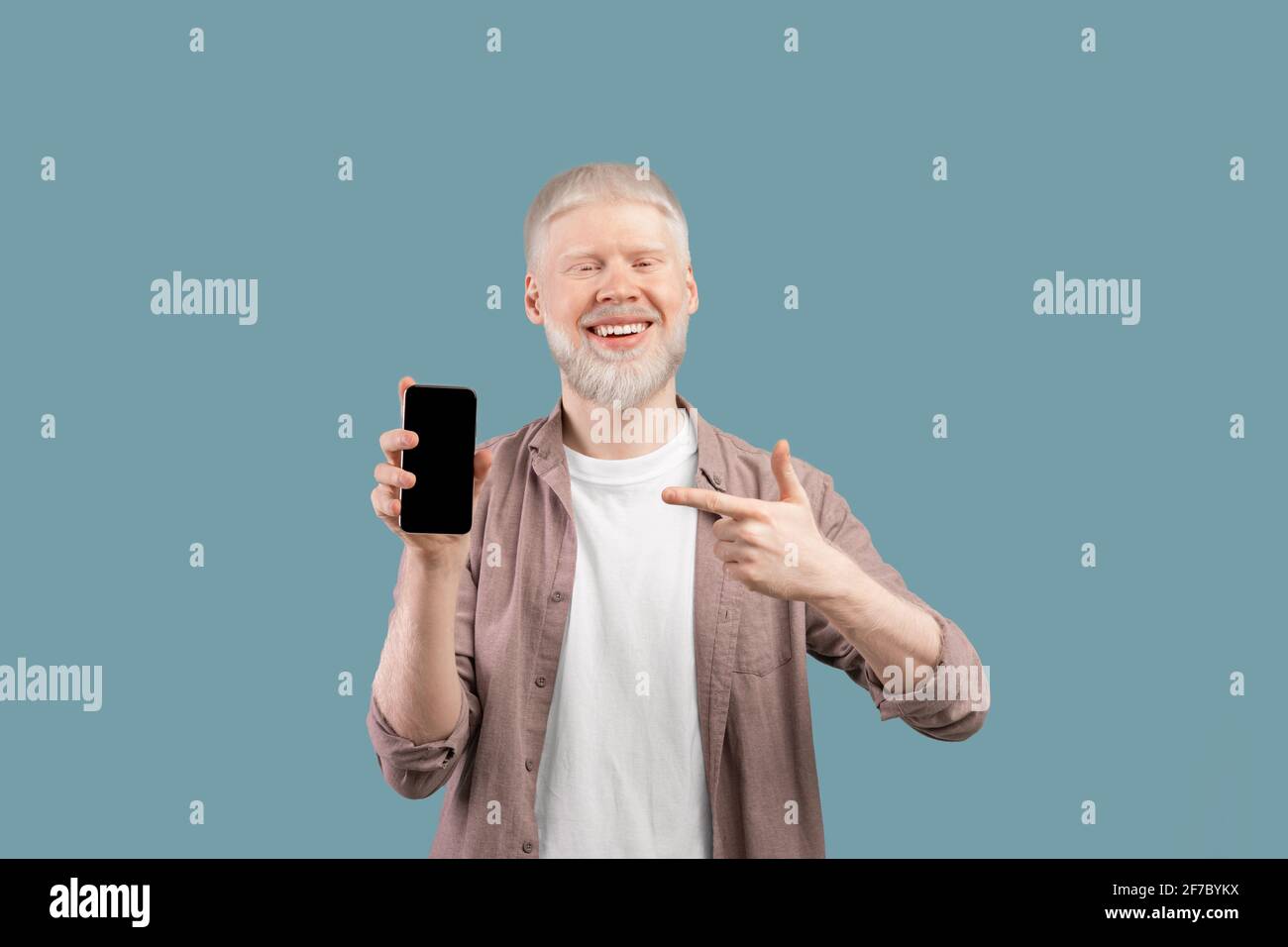 Check this app. Joyful albino guy holding and pointing finger at ...