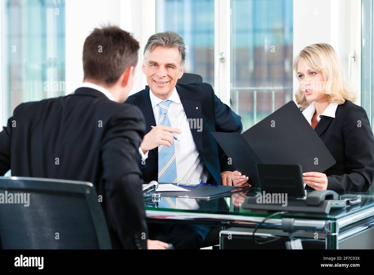 Business - young man sitting in job Interview Stock Photo - Alamy