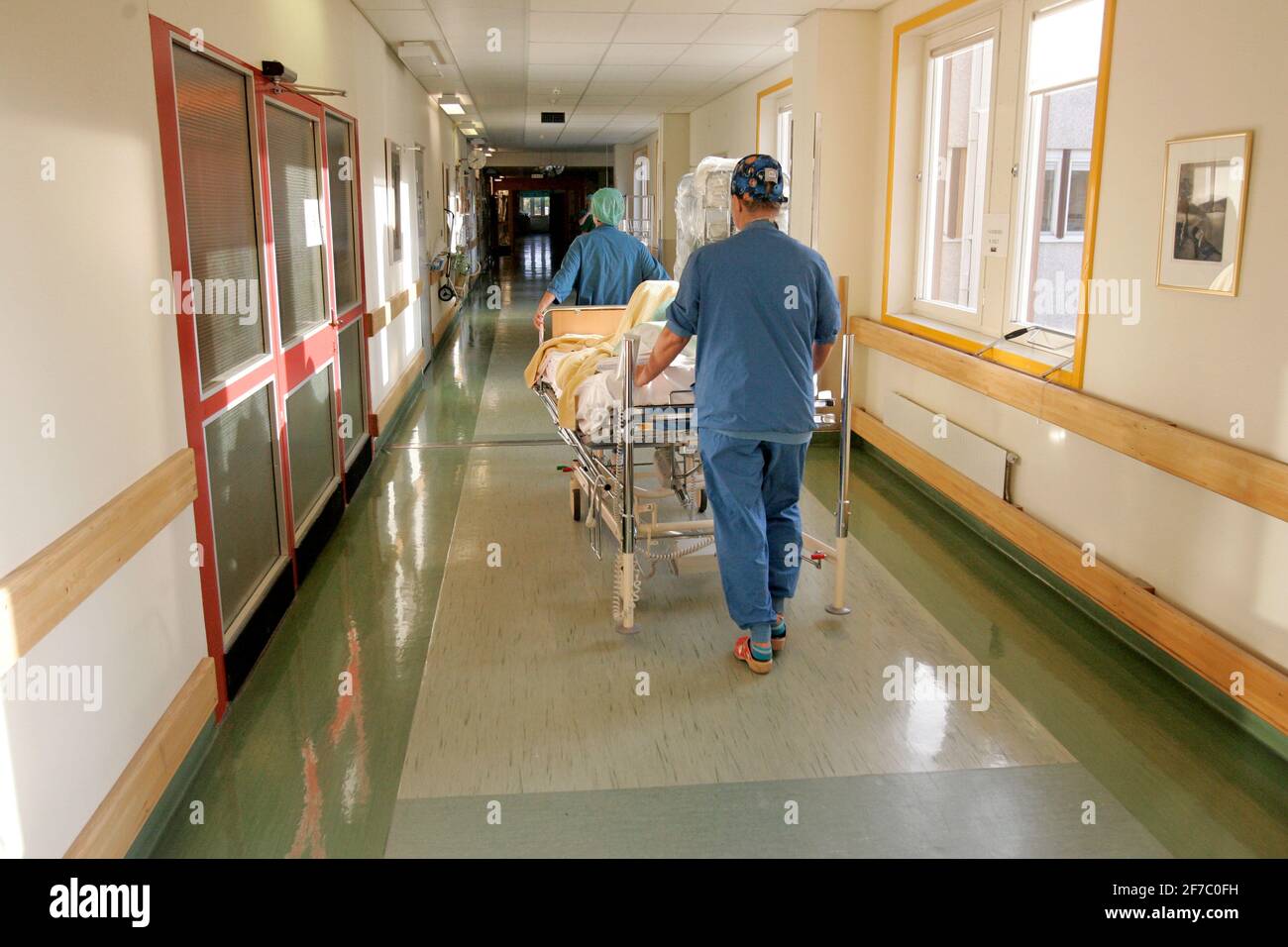 Healthcare staff transporting a patient in a hospital bed, Linköping ...