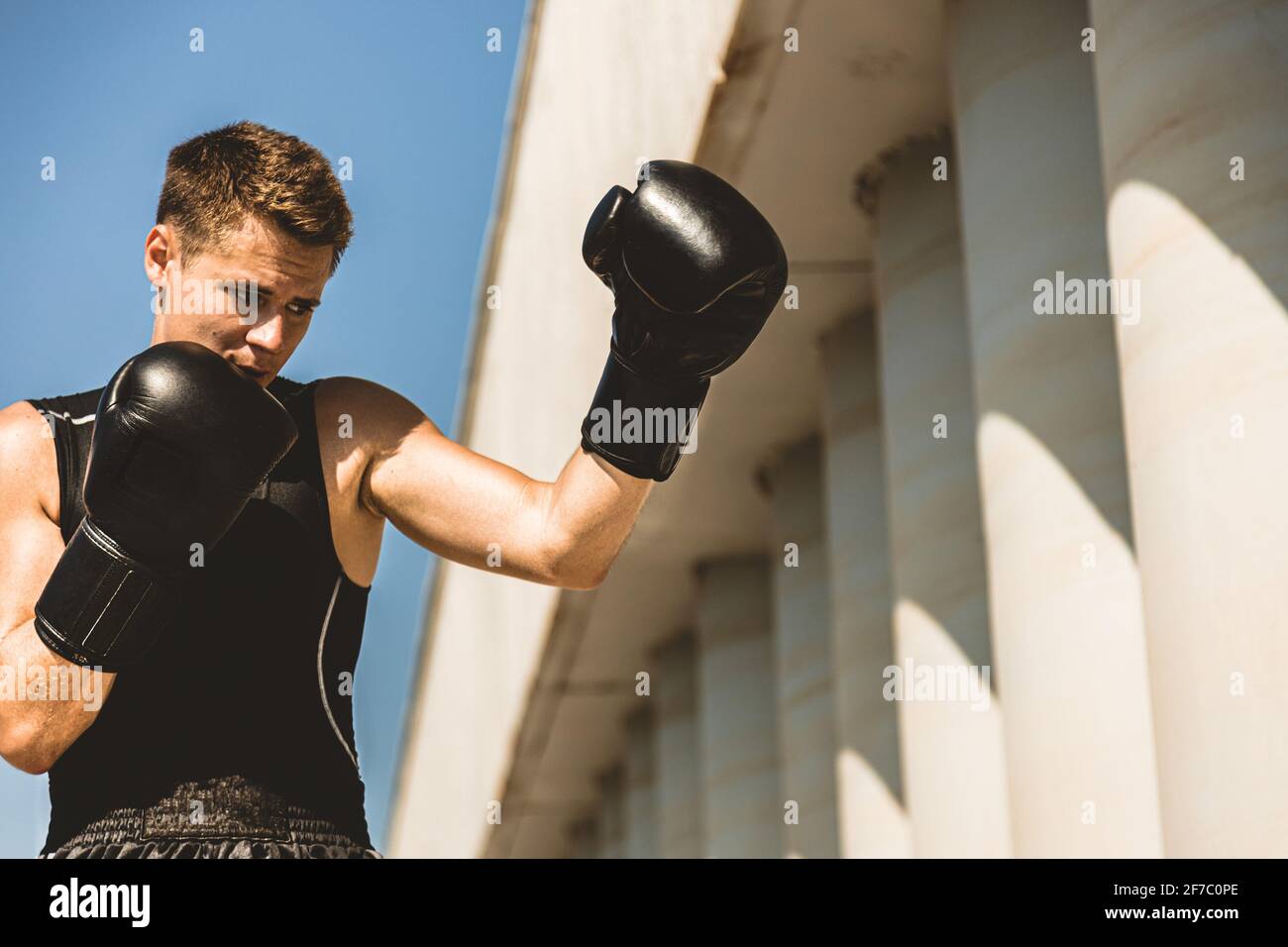 Man exercising and fighting in outside, boxer in gloves. male boxer ...