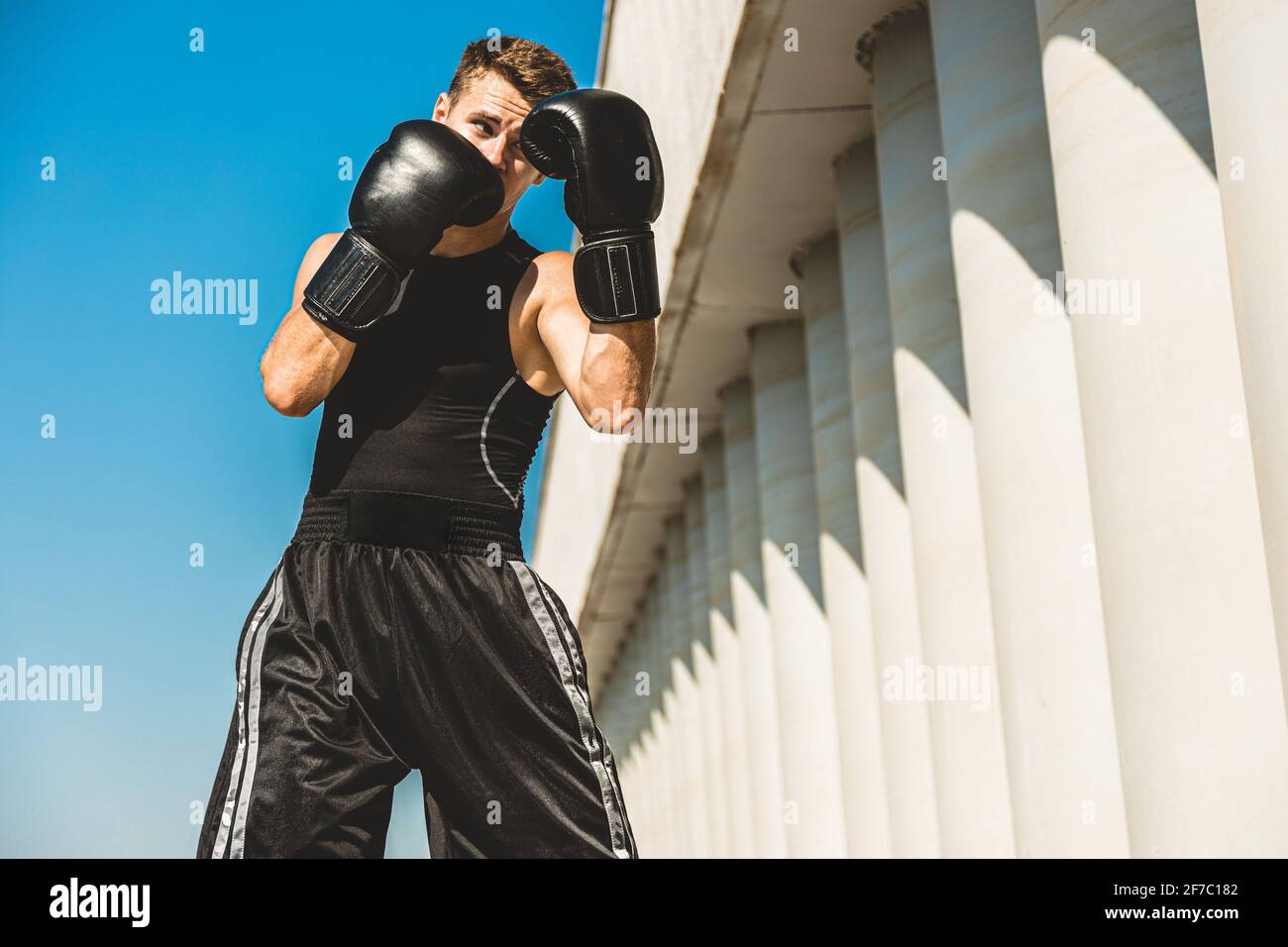 Man exercising and fighting in outside, boxer in gloves. male boxer ...