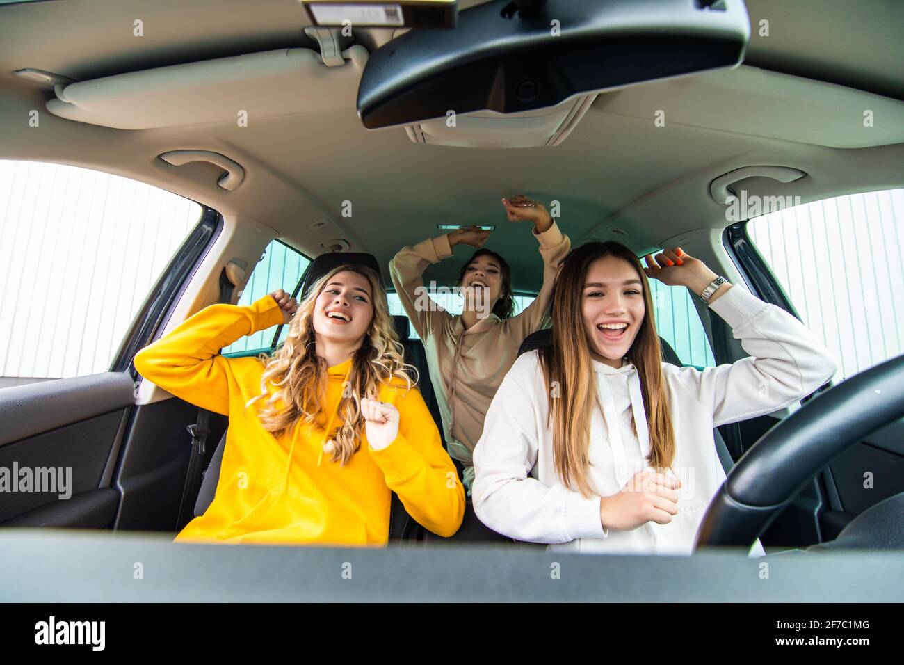 Group Of Girls Having Fun In The Car Women Friends Singing Songs And