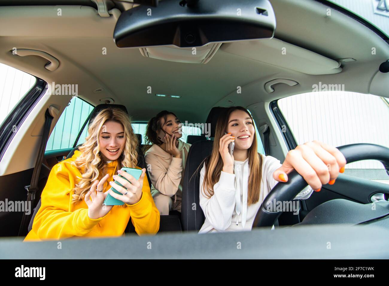 Three best friends in the car and use smart phone while drive car Stock ...