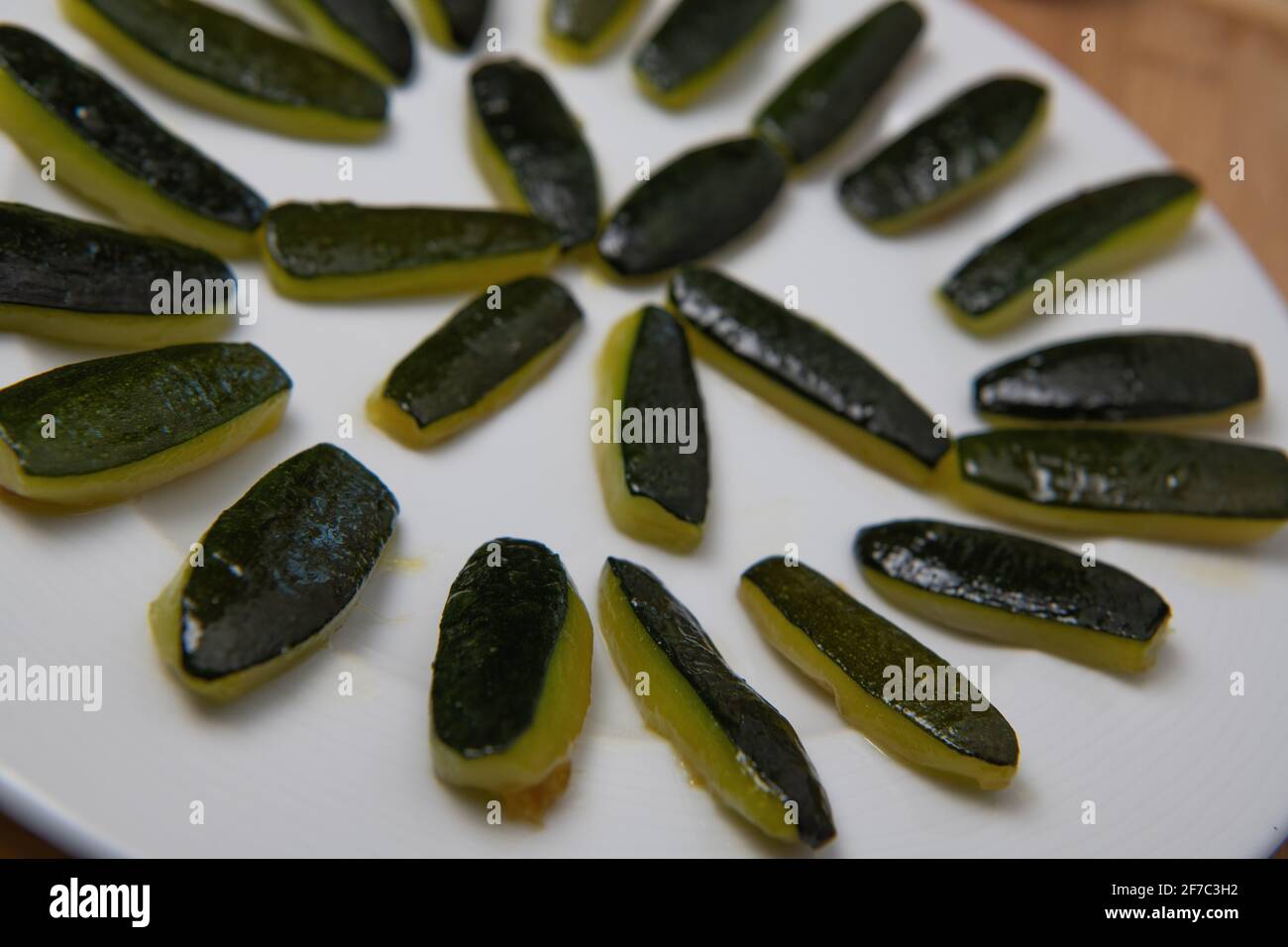 Preparing fresh cooked courgette, zucchini on wood table Stock Photo ...