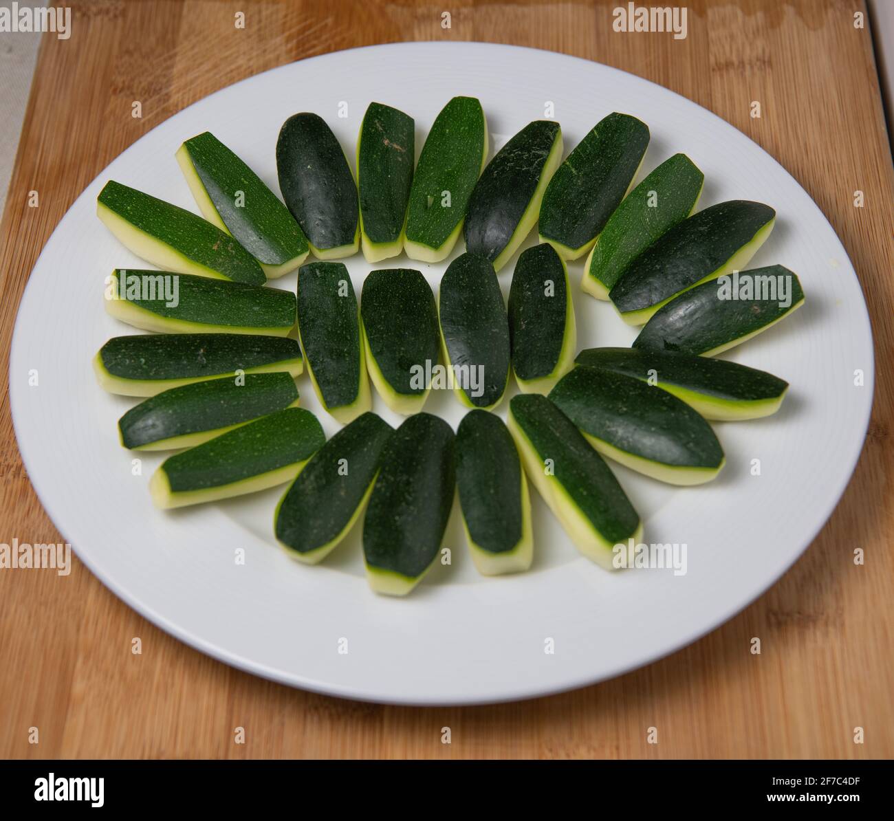Preparing fresh courgette, zucchini on wood table Stock Photo - Alamy