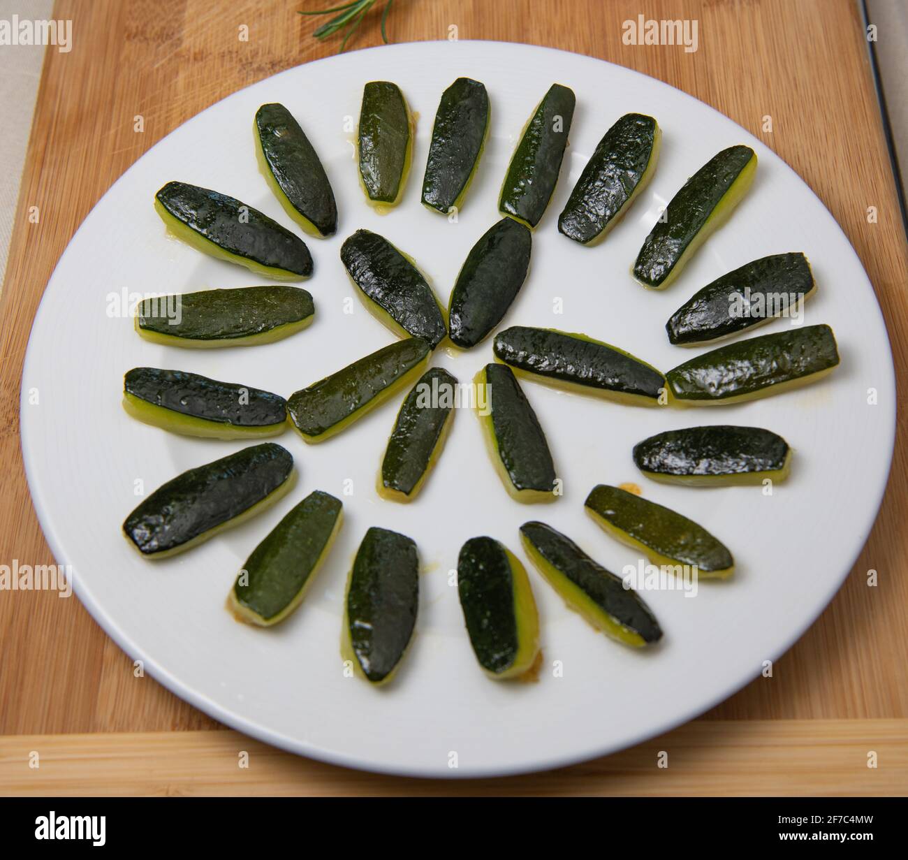 Preparing fresh cooked courgette, zucchini on wood table Stock Photo ...
